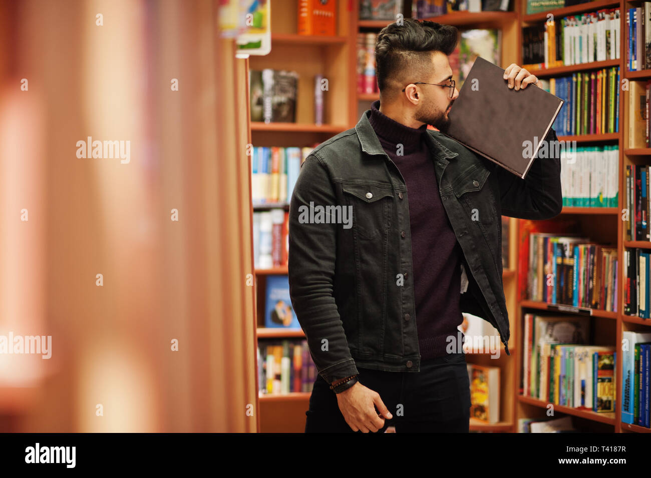 Tall smart arab student man, wear on black jeans jacket and eyeglasses ...