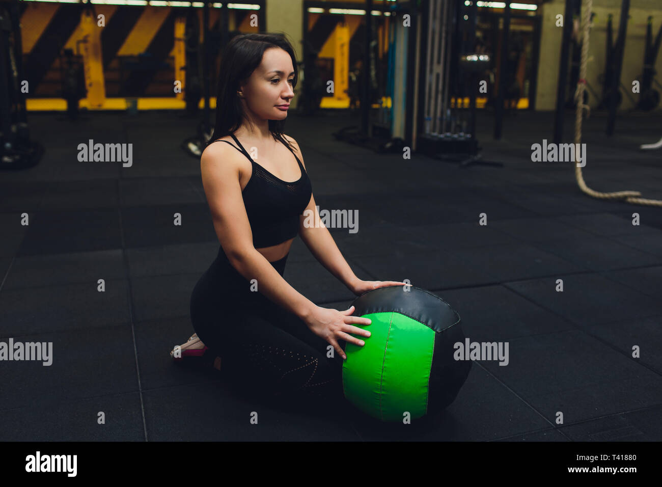 Muscular woman doing intense core workout in gym. Strong female doing ...
