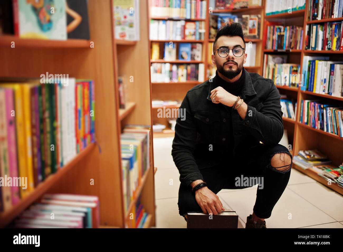 Tall smart arab student man, wear on black jeans jacket and eyeglasses ...