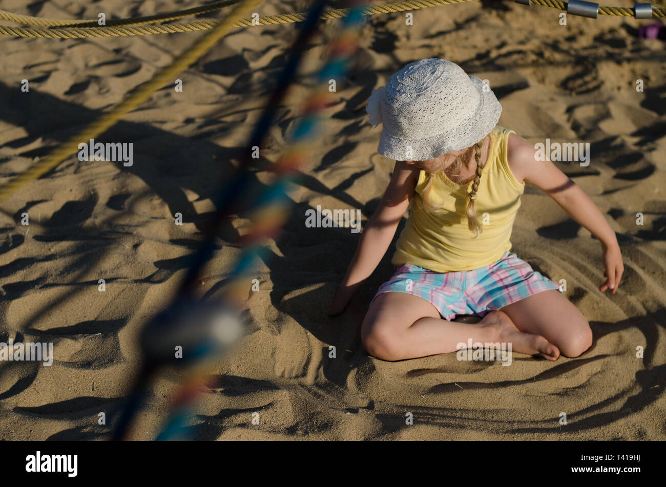 little girl playing in sand playground Stock Photo - Alamy