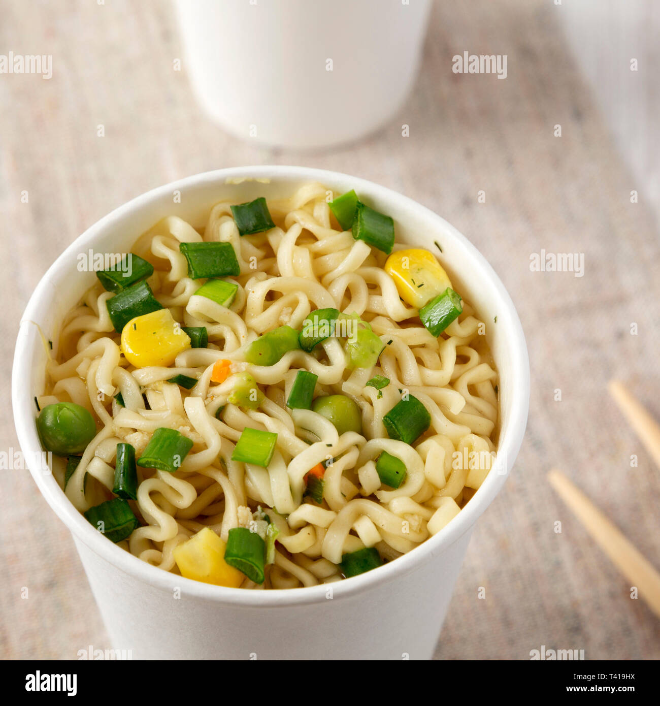 Instant ramen noodles in paper cups, low angle view. Close-up Stock ...
