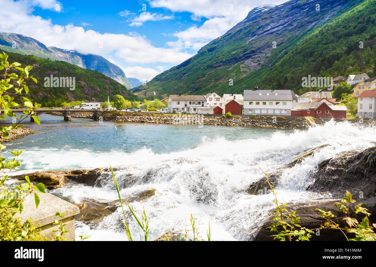 Landscape with mountains, houses, bridge and river in Hellesylt, Norway ...
