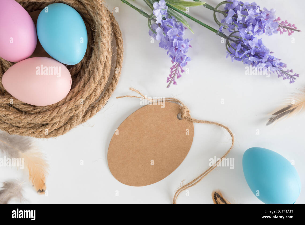 Blank rustic egg-shaped gift tag on white background with nest, pastel ...