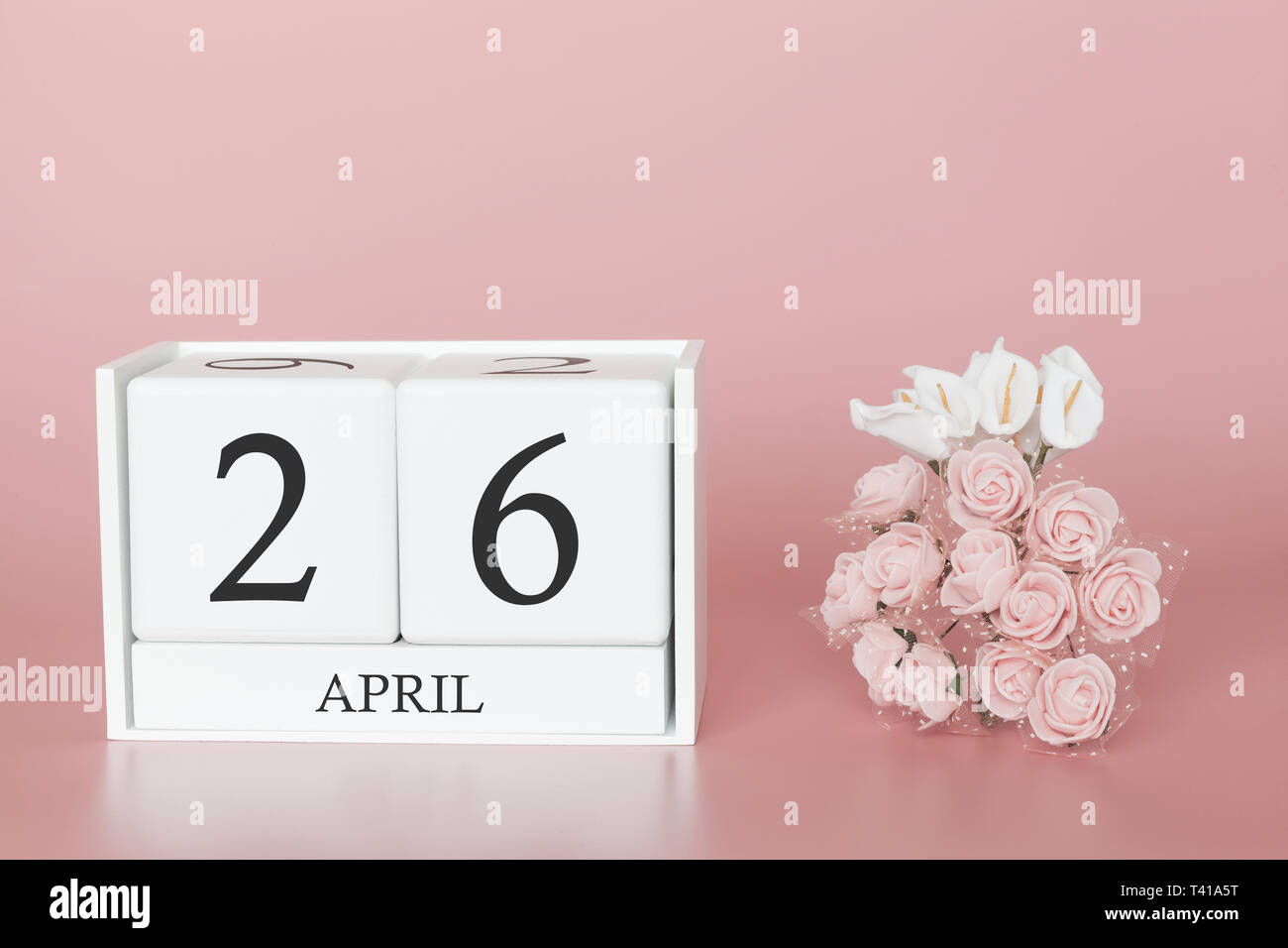April 26th. Day 26 of month. Calendar cube on modern pink background ...