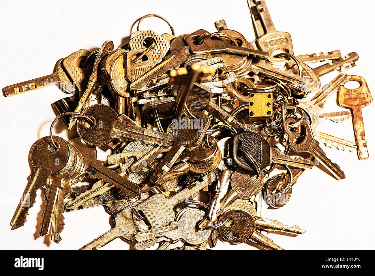 Many keys of different sizes. Keys on a white background, close-up ...
