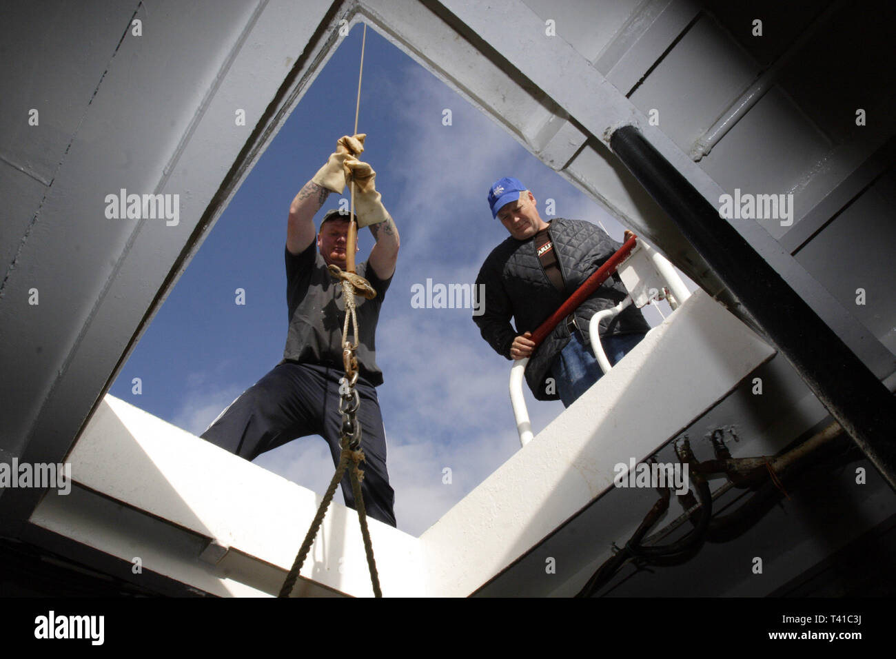 Loading Ice fishing trawler in the Irish Sea. 4-man crew work on 1 of ...
