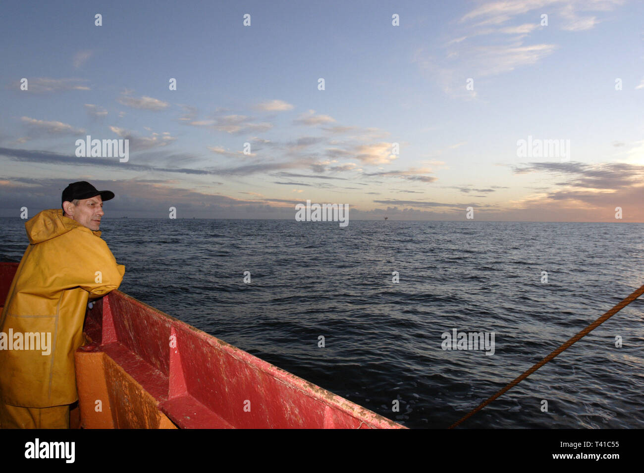 On board a fishing trawler in the Irish Sea. 4-man crew work on 1 of ...