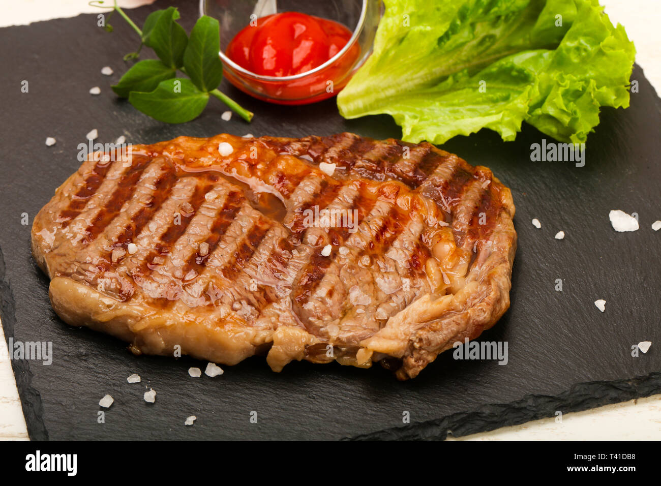 Grilled Rib eye steak with sauce Stock Photo - Alamy