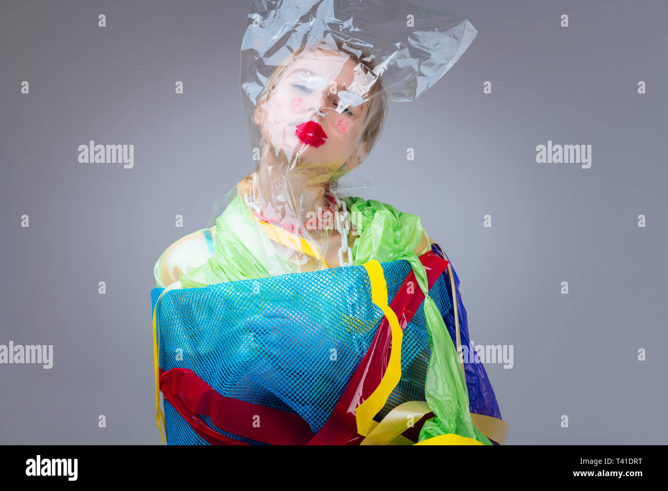 Plastic clothes. Young professional model wearing plasticated clothing ...