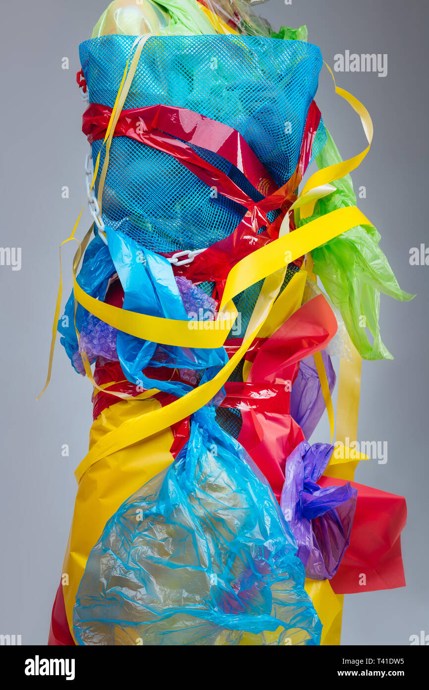 Wrapped in plastic. Female model having her body wrapped in colorful ...