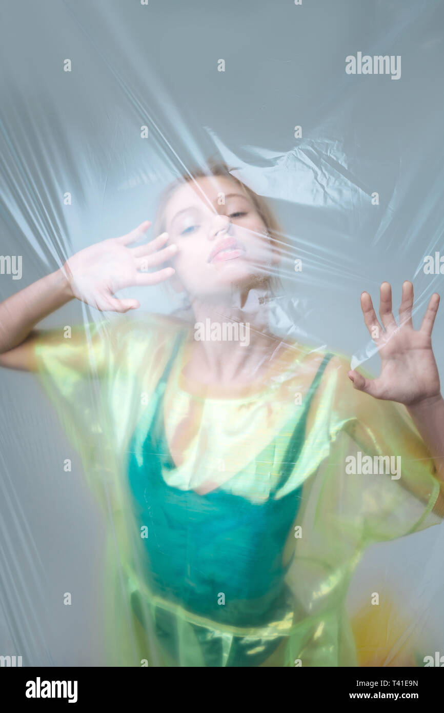 Transparent plastic. Model wearing green bodysuit and non-natural ...