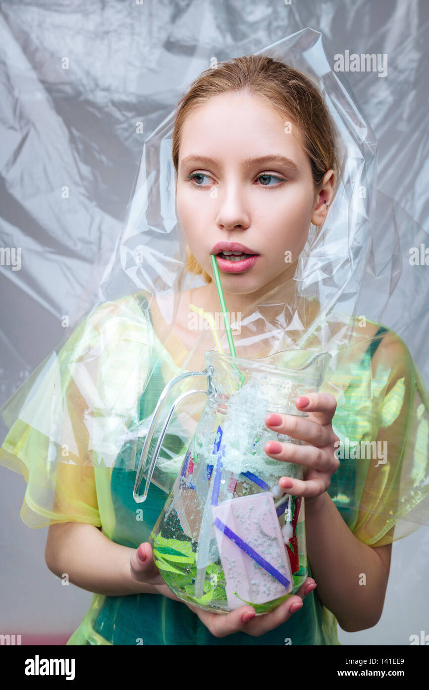 Holding glass jar. Young beautiful model holding glass jar with plastic ...
