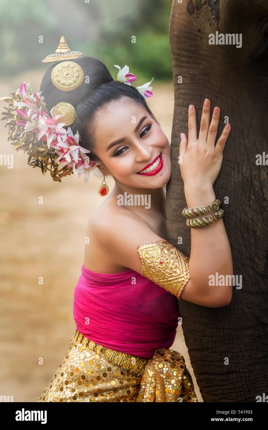 Pretty thai girl in traditional thai dress with elephant Stock Photo ...