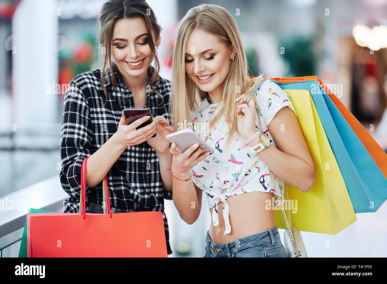 Pretty girls posing while shopping Stock Photo - Alamy