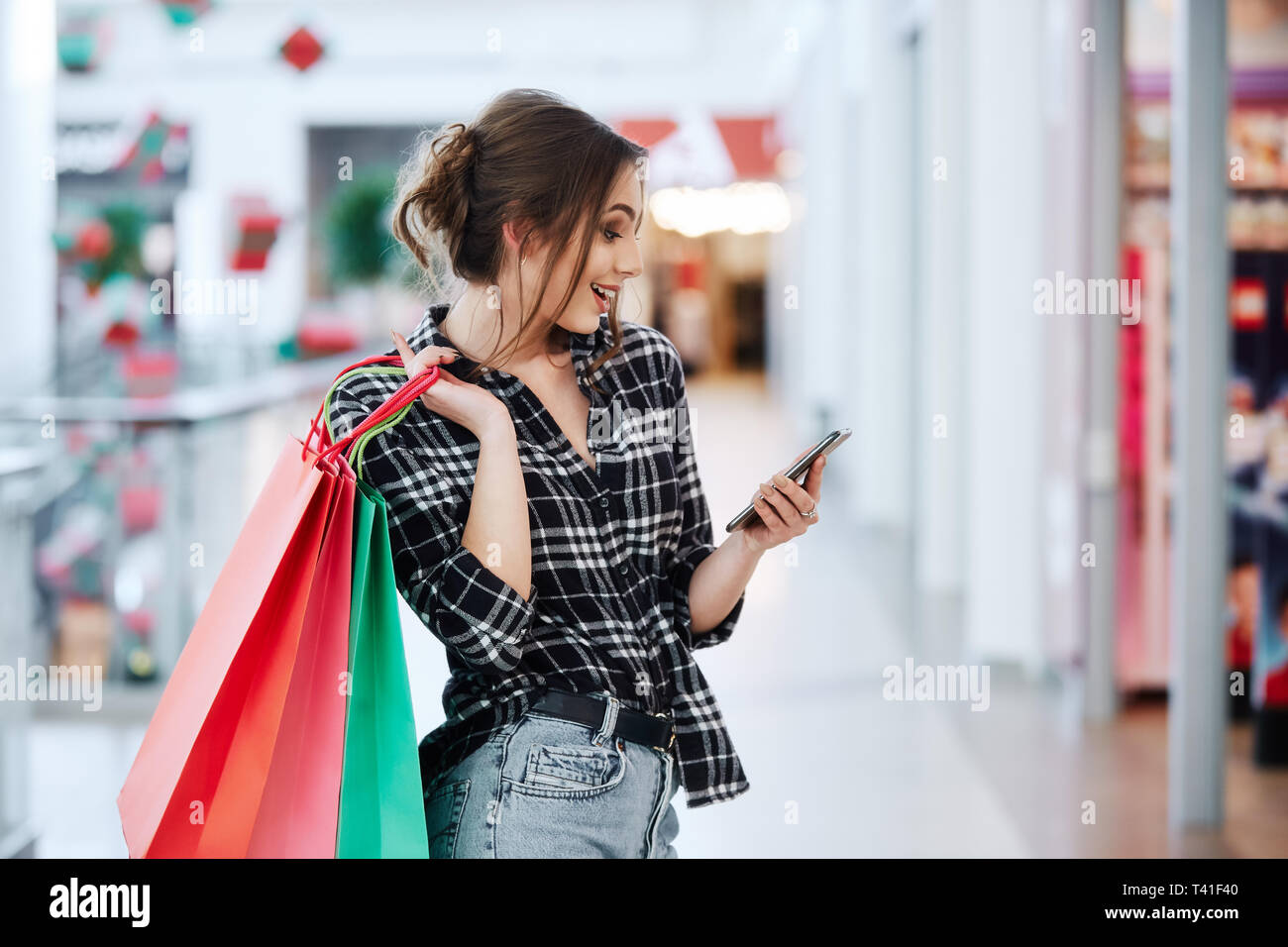 Cute girl posing at shopping mall Stock Photo - Alamy