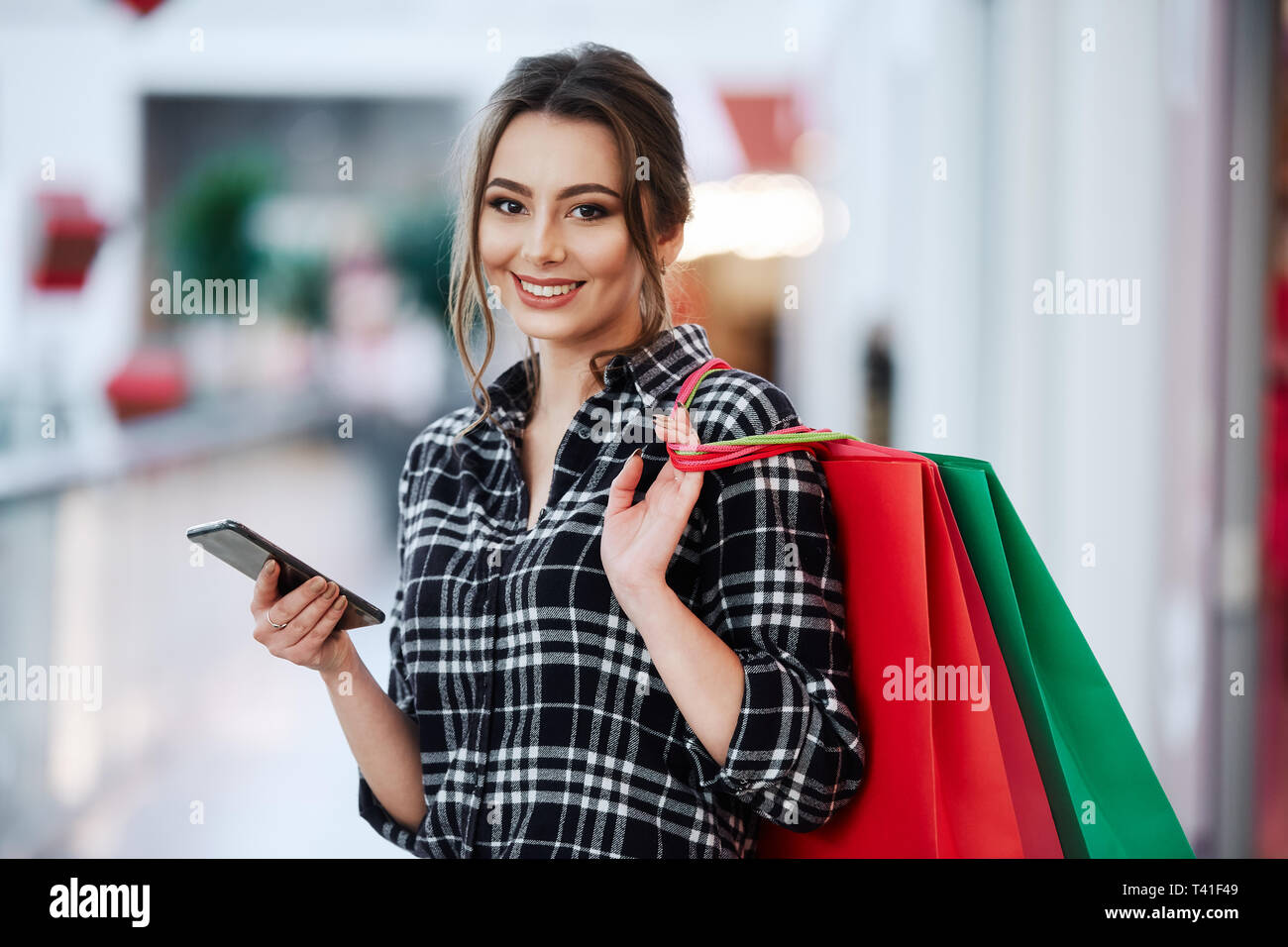 Cute girl posing at shopping mall Stock Photo - Alamy