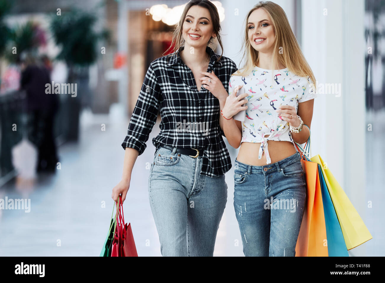 Pretty girls posing while shopping Stock Photo - Alamy