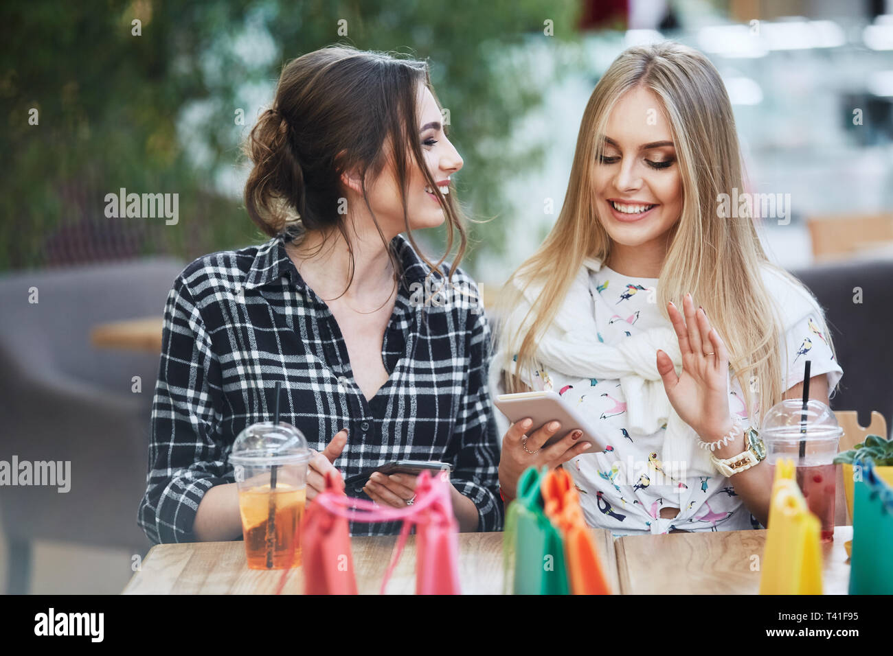 Pretty girls posing while shopping Stock Photo - Alamy