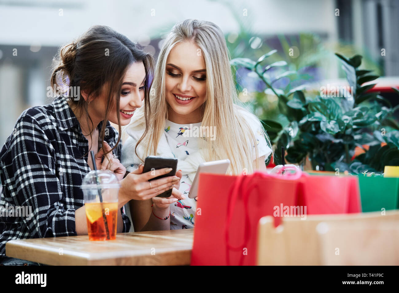 Gorgeous girls in shopping mall Stock Photo - Alamy
