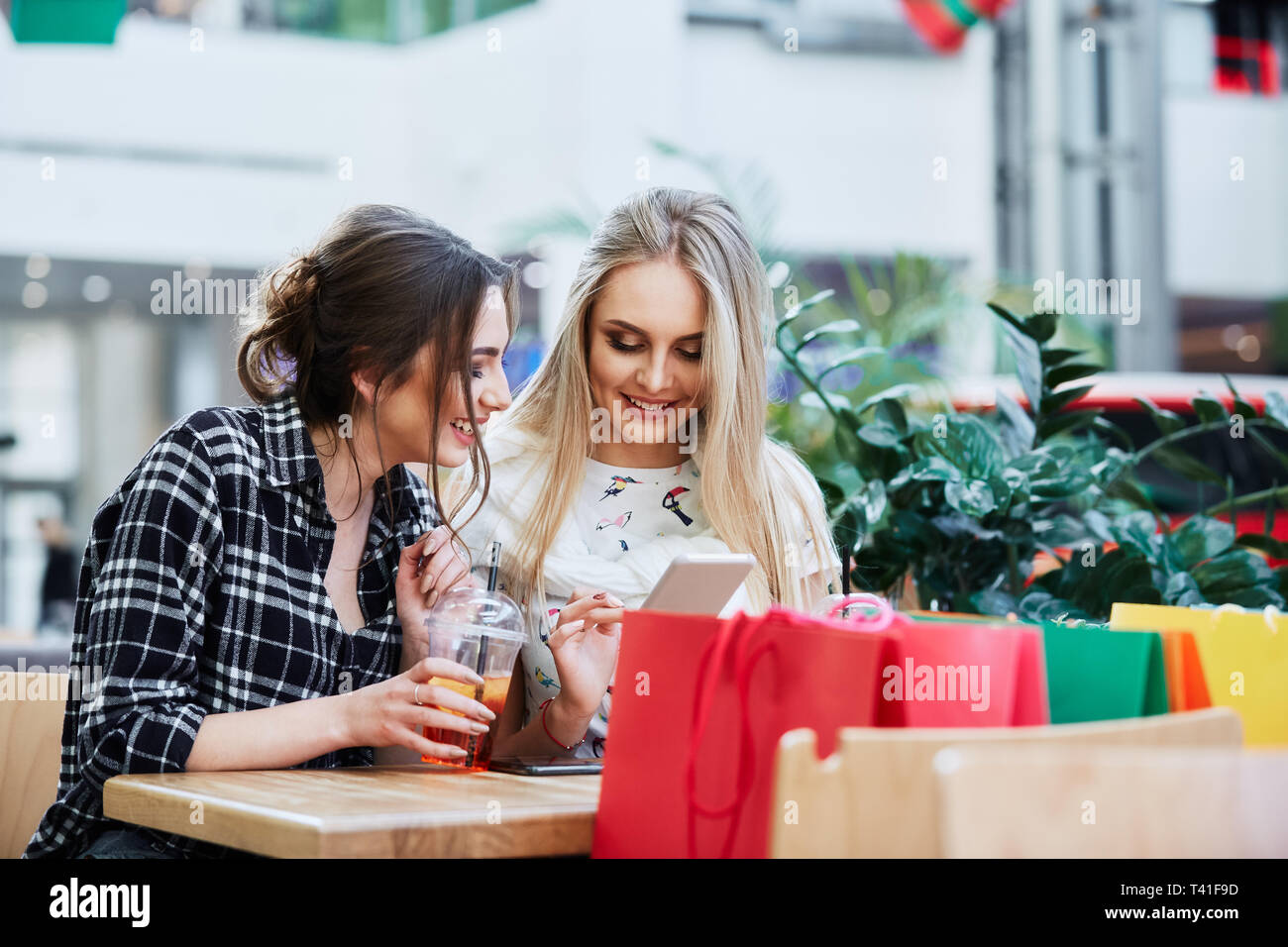 Pretty girls posing while shopping Stock Photo - Alamy