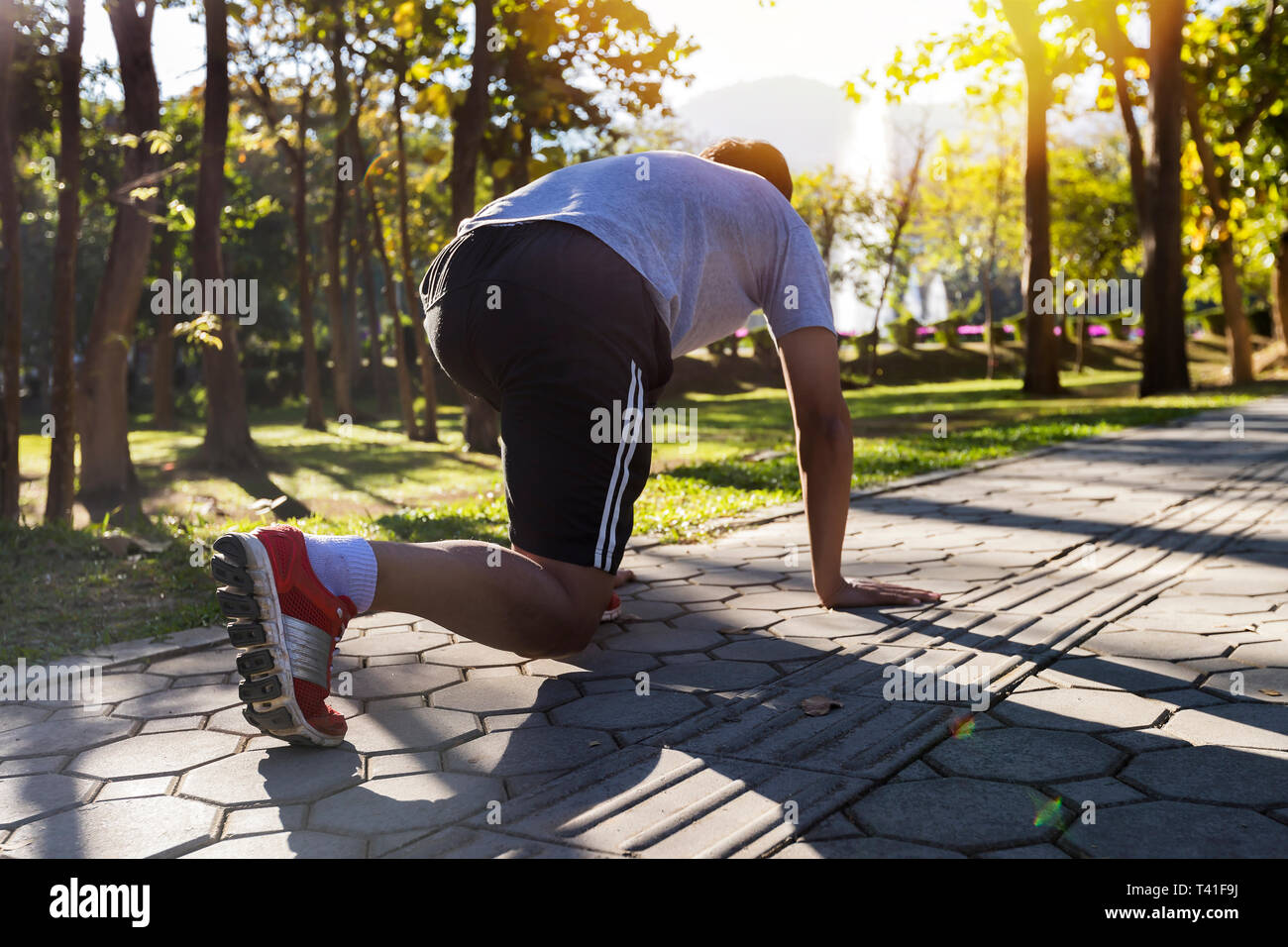 Ready to go! Close up cropped low angle photo of shoe of athlete man in ...