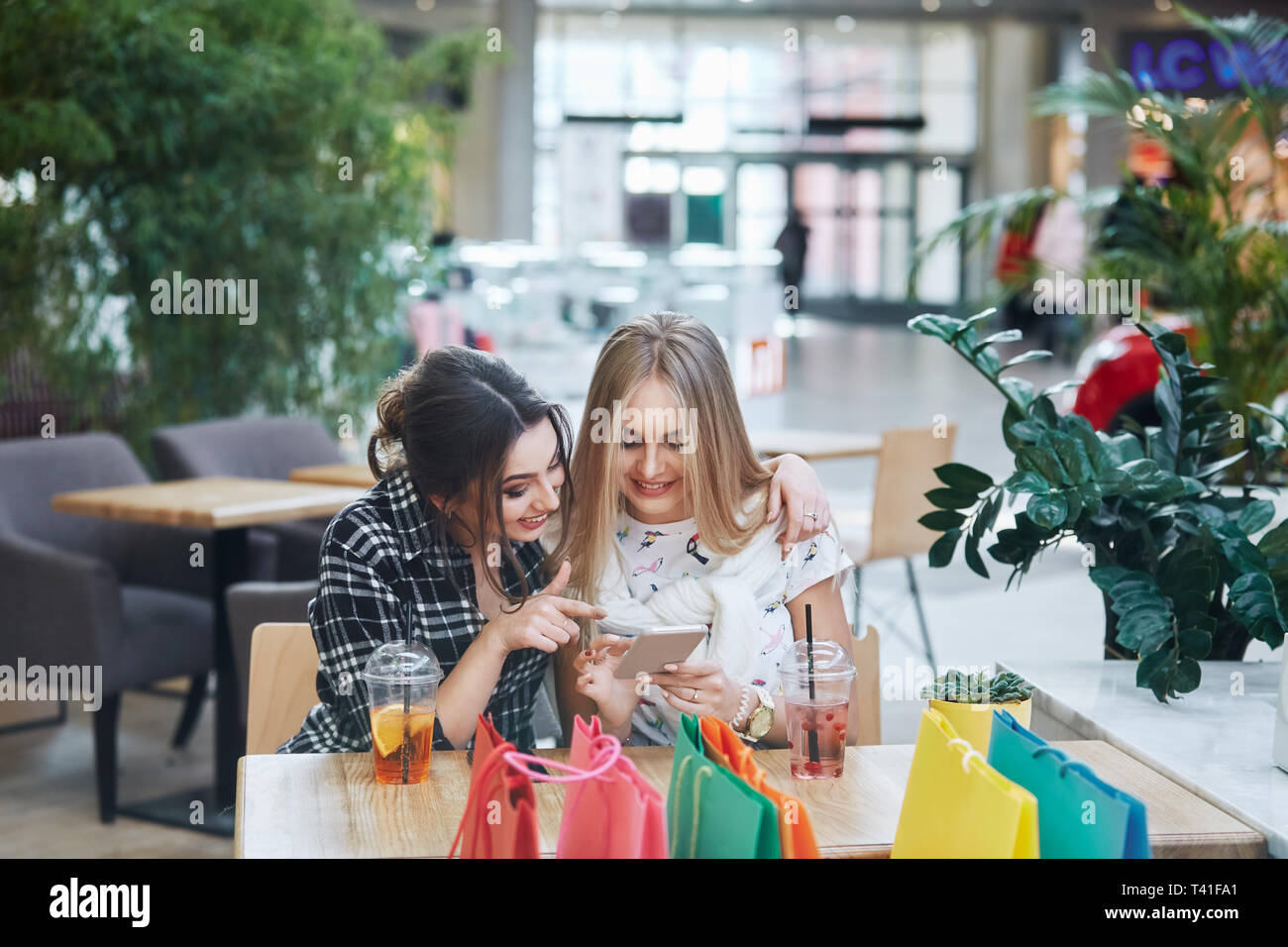 Gorgeous girls in shopping mall Stock Photo - Alamy