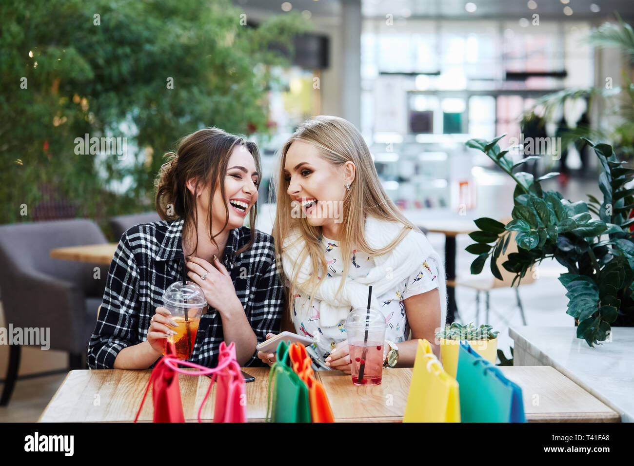 Gorgeous girls in shopping mall Stock Photo - Alamy