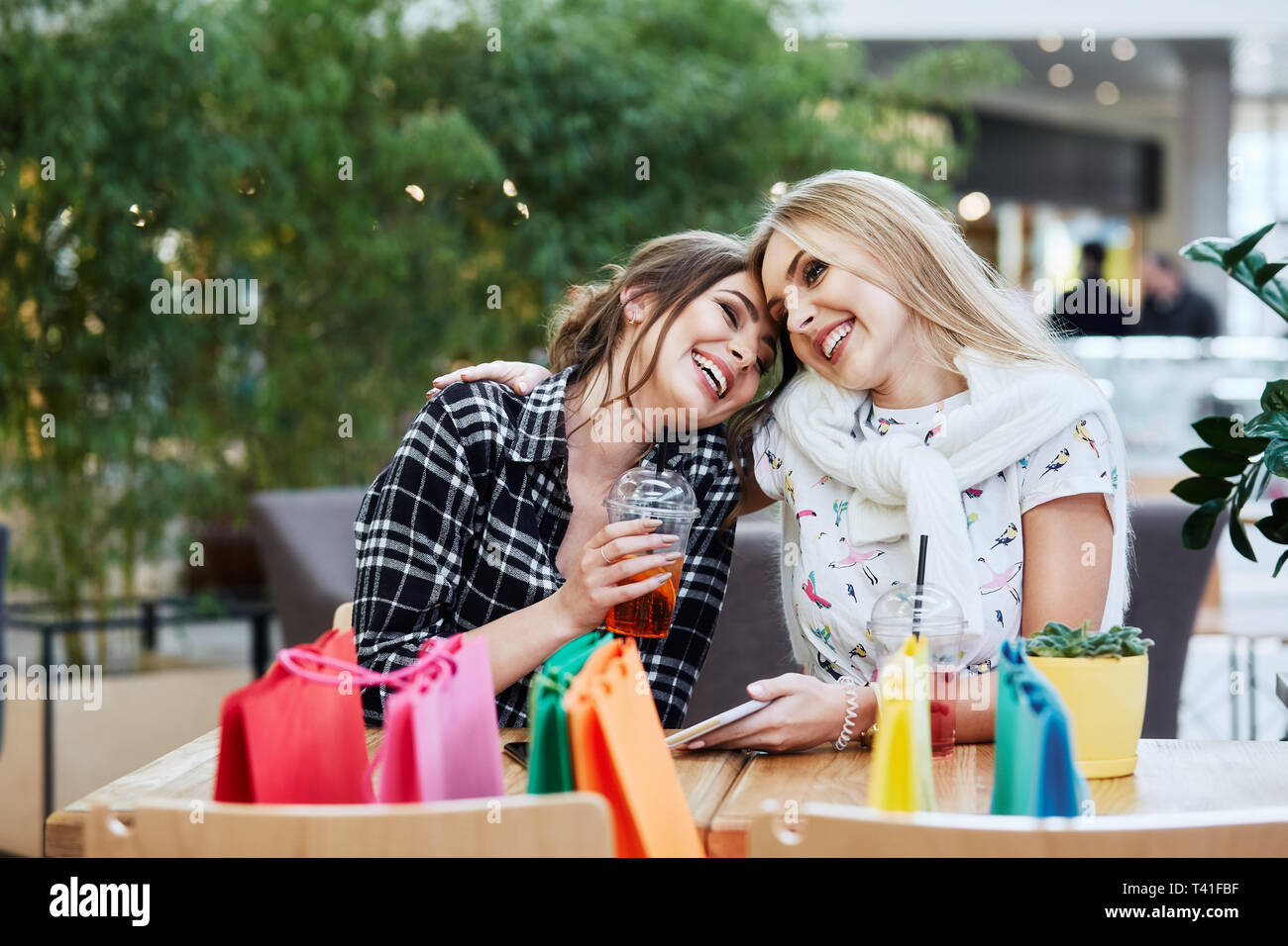 Gorgeous girls in shopping mall Stock Photo - Alamy