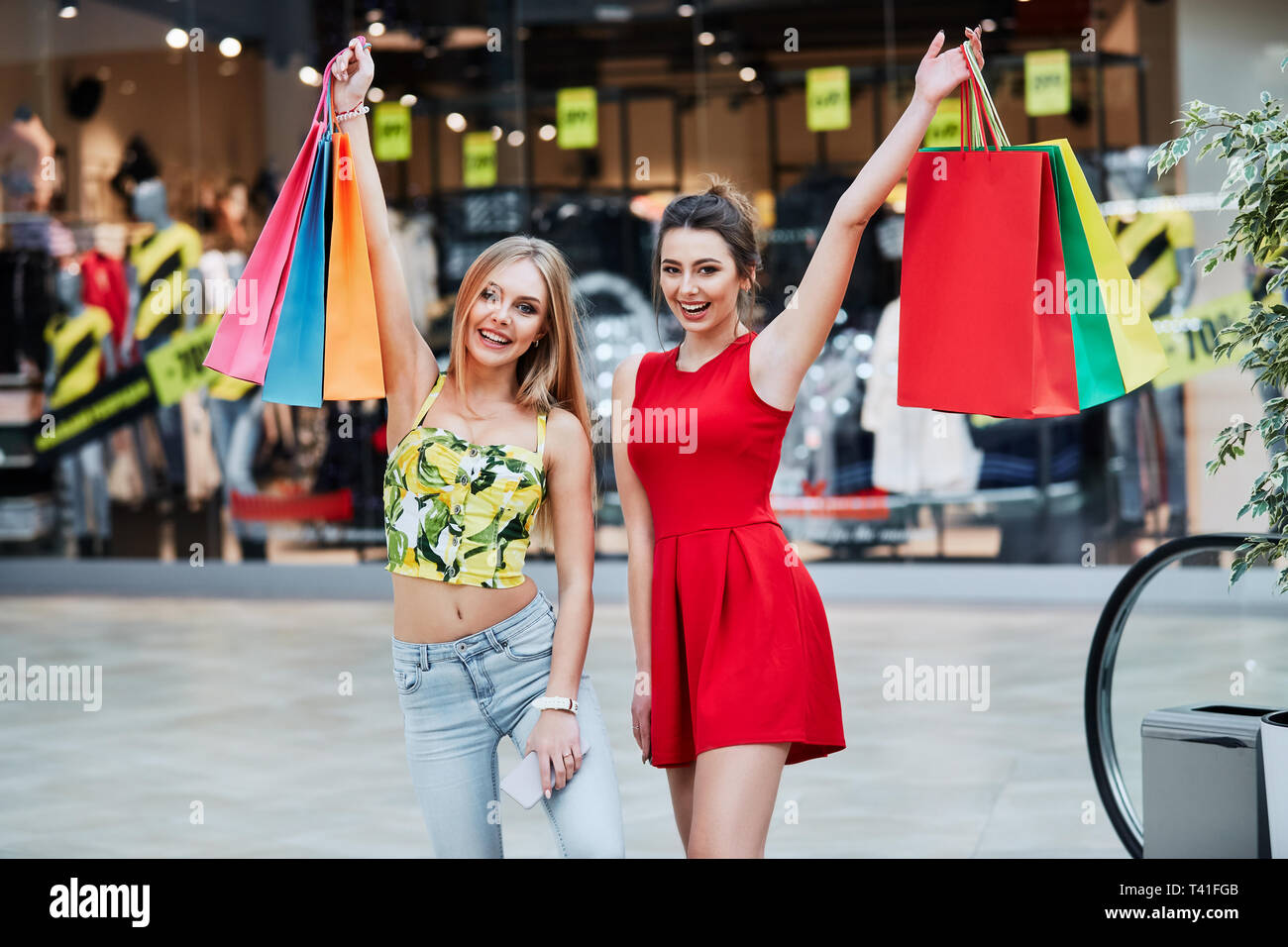 Gorgeous girls in shopping mall Stock Photo - Alamy
