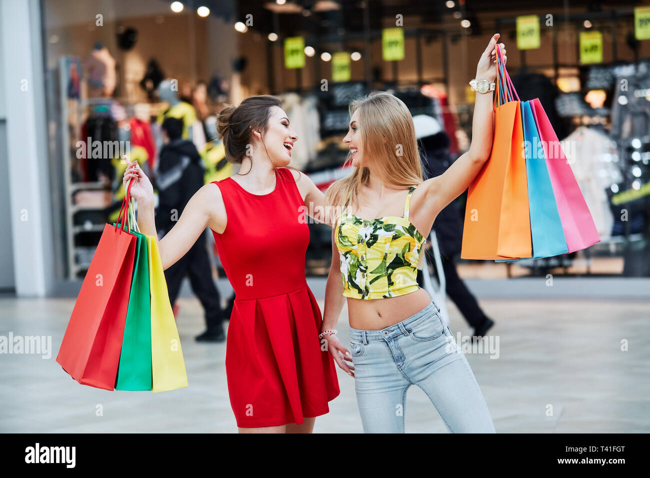 Pretty girls posing while shopping Stock Photo - Alamy