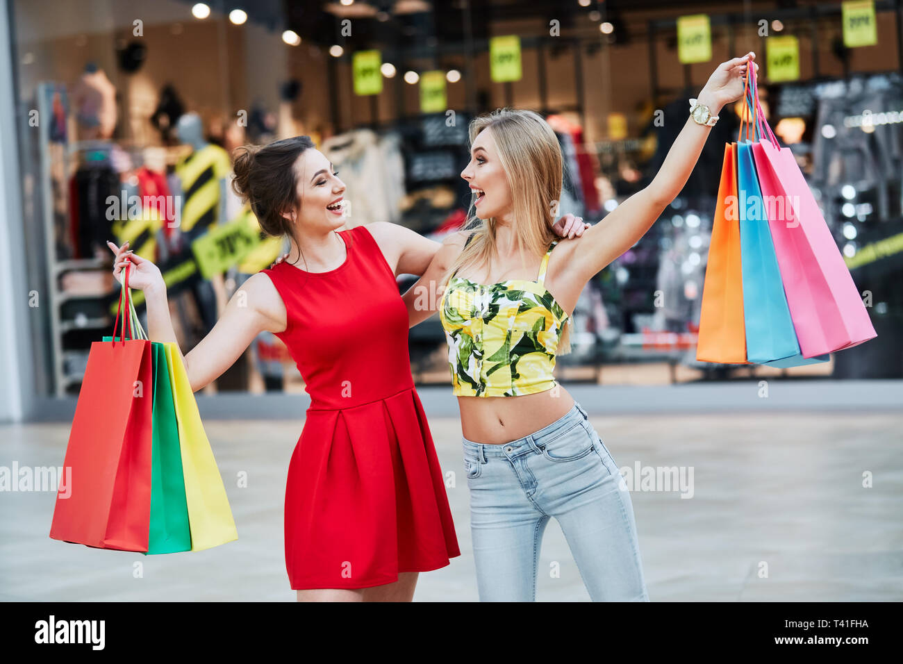 Gorgeous girls in shopping mall Stock Photo - Alamy