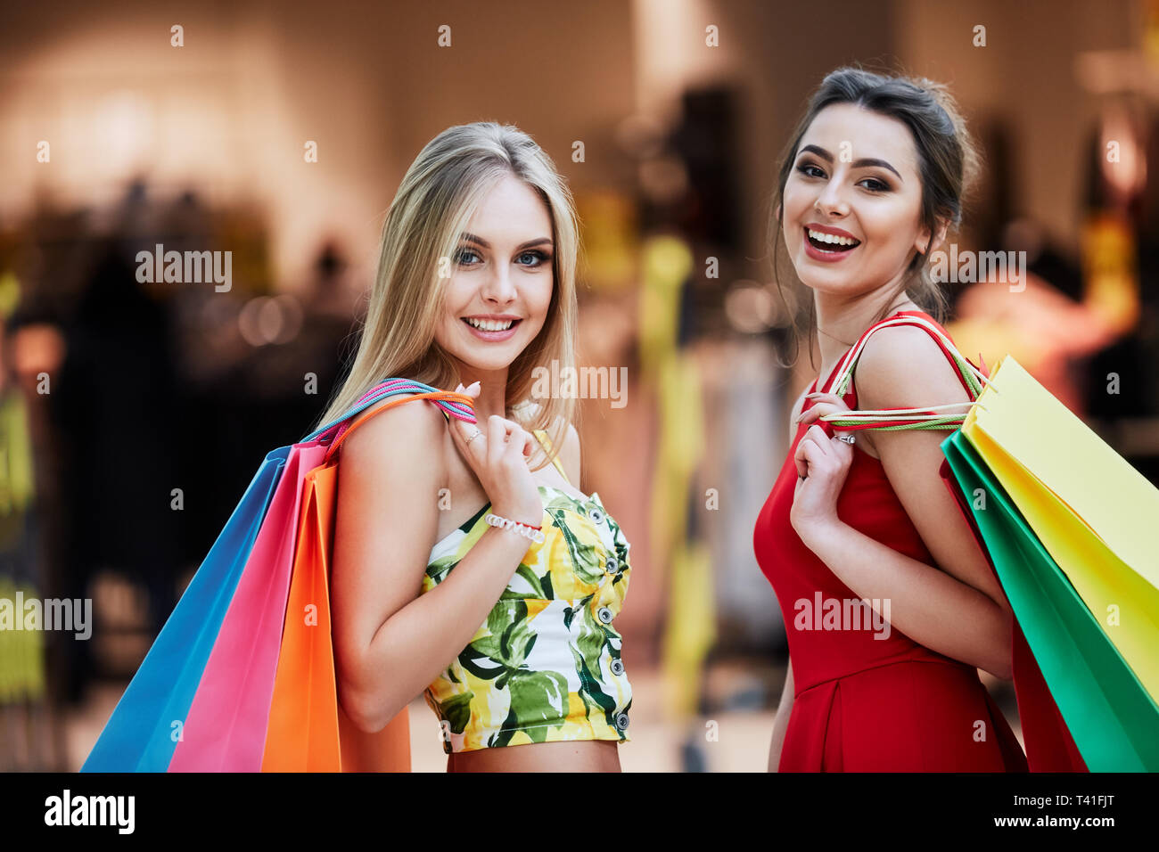 Pretty girls posing while shopping Stock Photo - Alamy