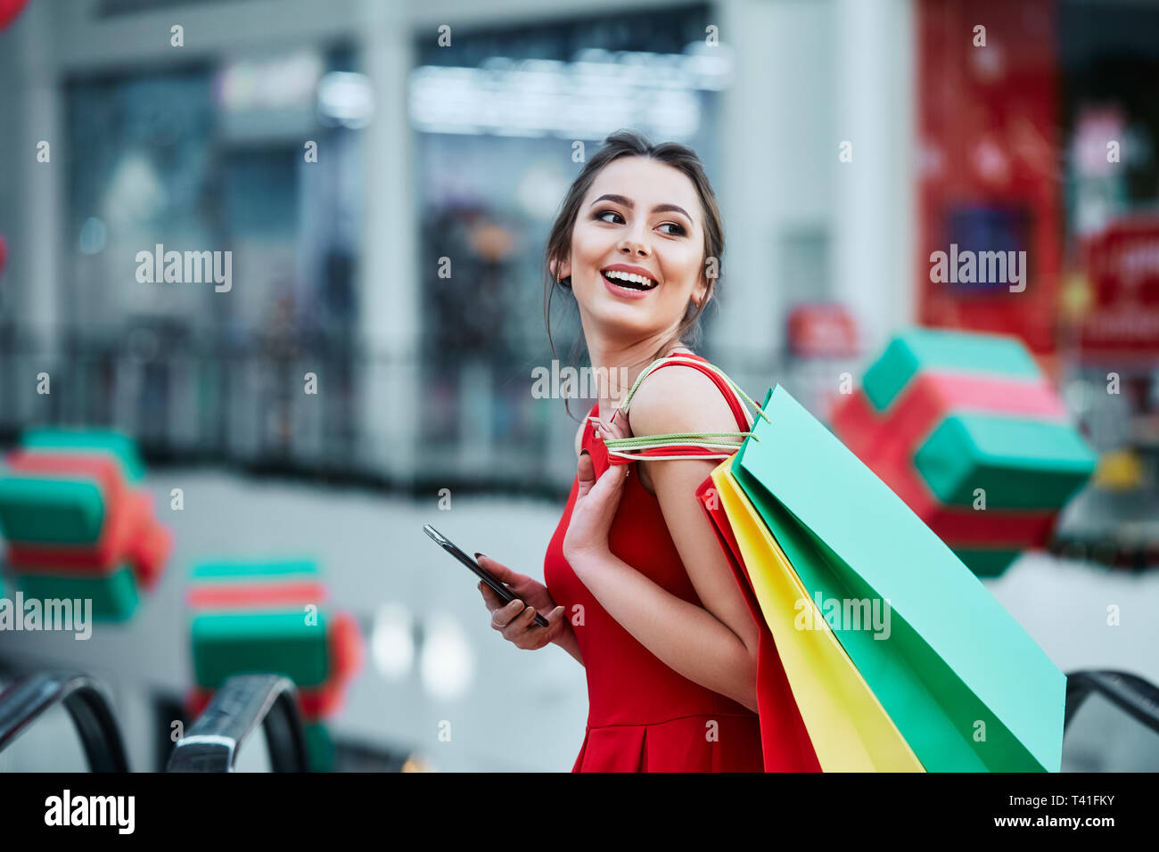 Cute girl posing at shopping mall Stock Photo - Alamy