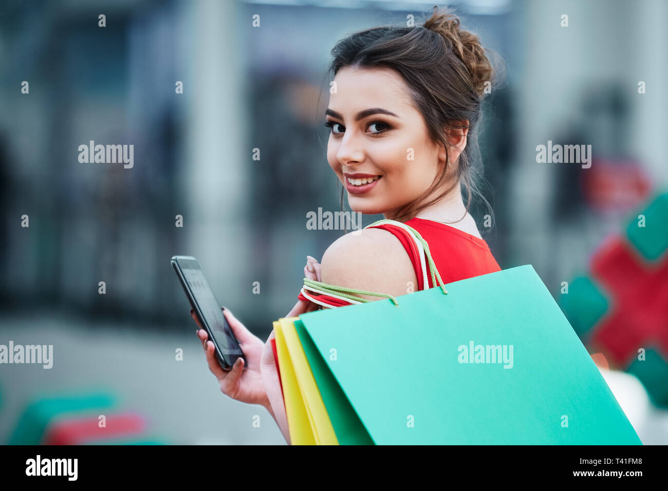 Cute girl posing at shopping mall Stock Photo - Alamy