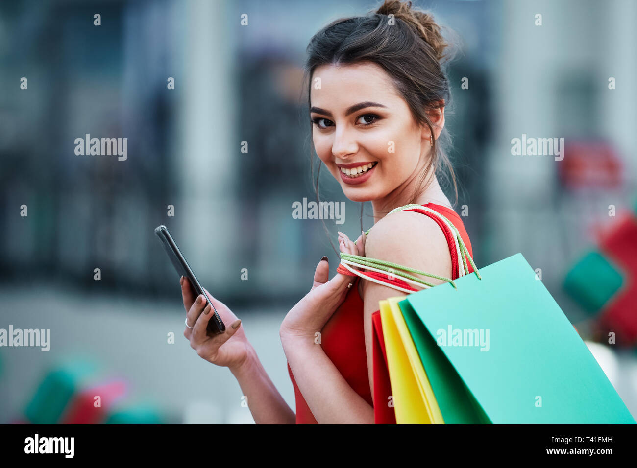 Cute girl posing at shopping mall Stock Photo - Alamy