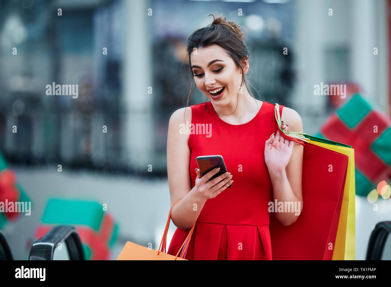 Cute girl posing at shopping mall Stock Photo - Alamy