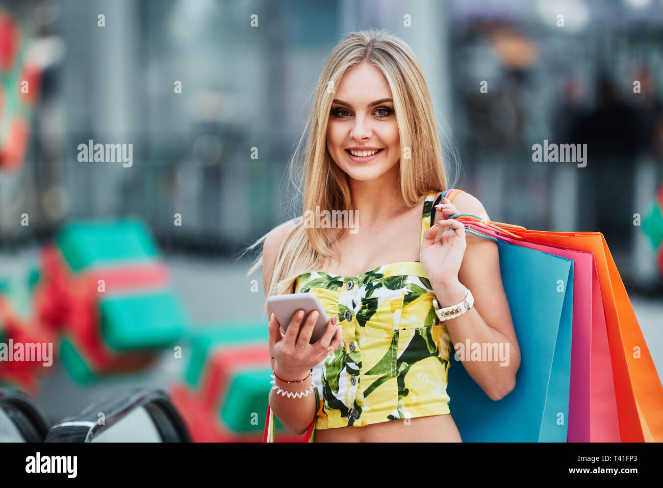 Cute girl posing at shopping mall Stock Photo - Alamy