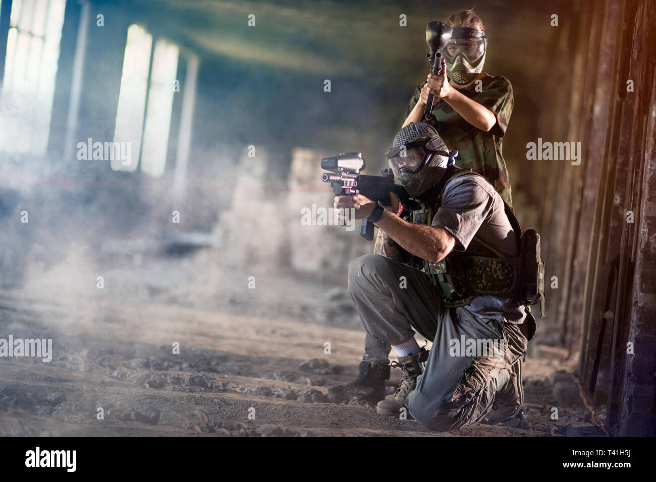 Paintball team together shooting in camouflage wear Stock Photo - Alamy