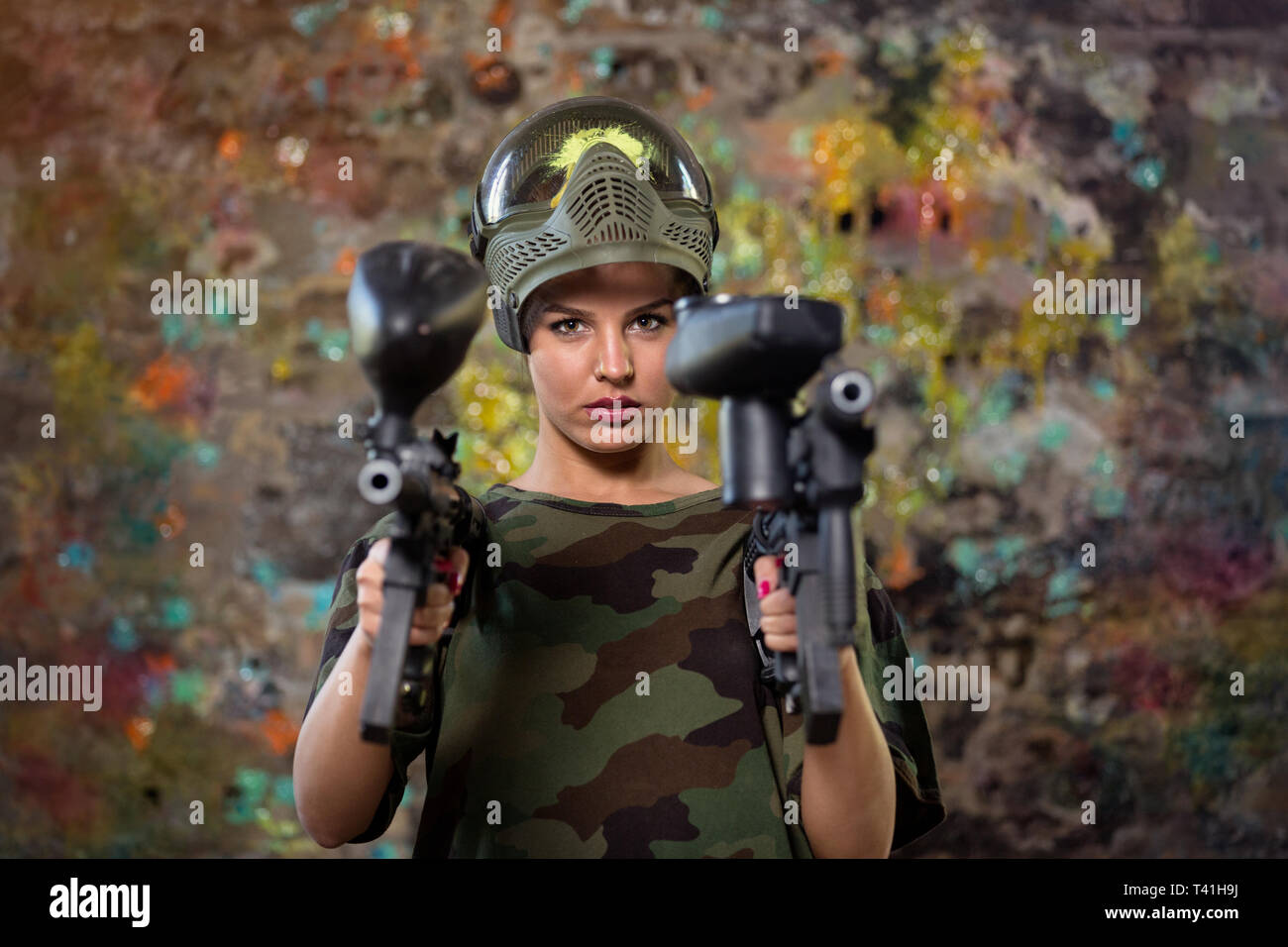 Beautiful paintball girl with guns Stock Photo - Alamy