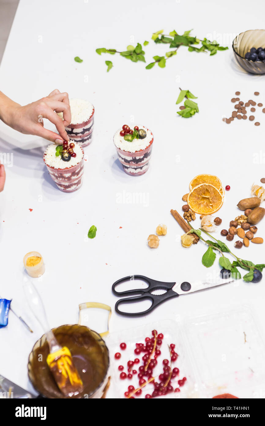 Decoration of the finished dessert. Pastry chef sprinkles confectionery ...