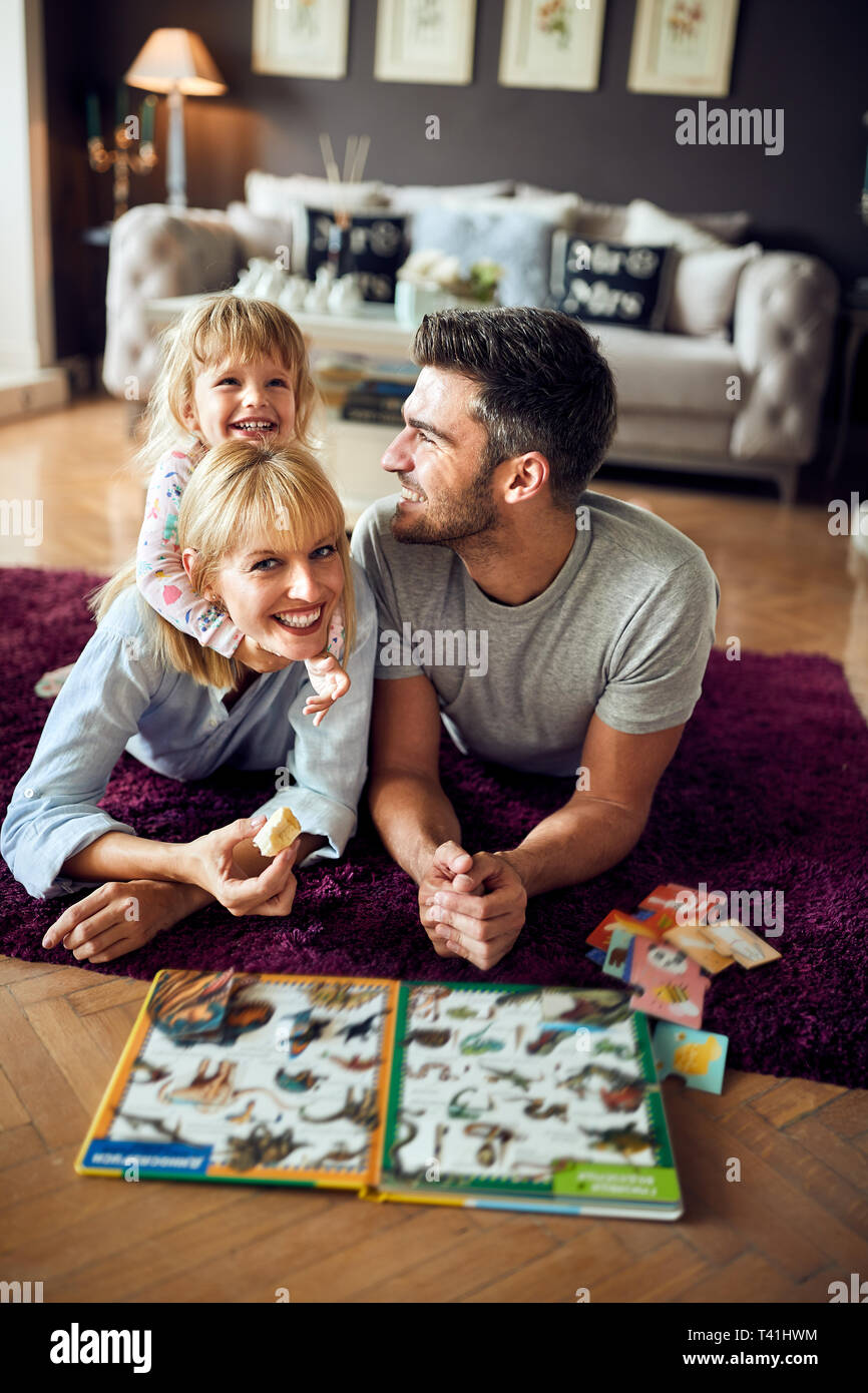 Daughter hugging mother at home while playing Stock Photo - Alamy
