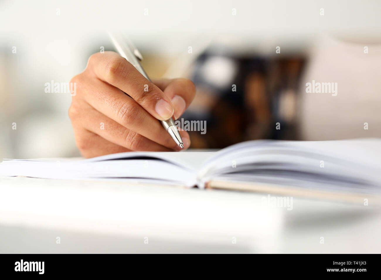 Arm of black woman write story in notebook Stock Photo - Alamy