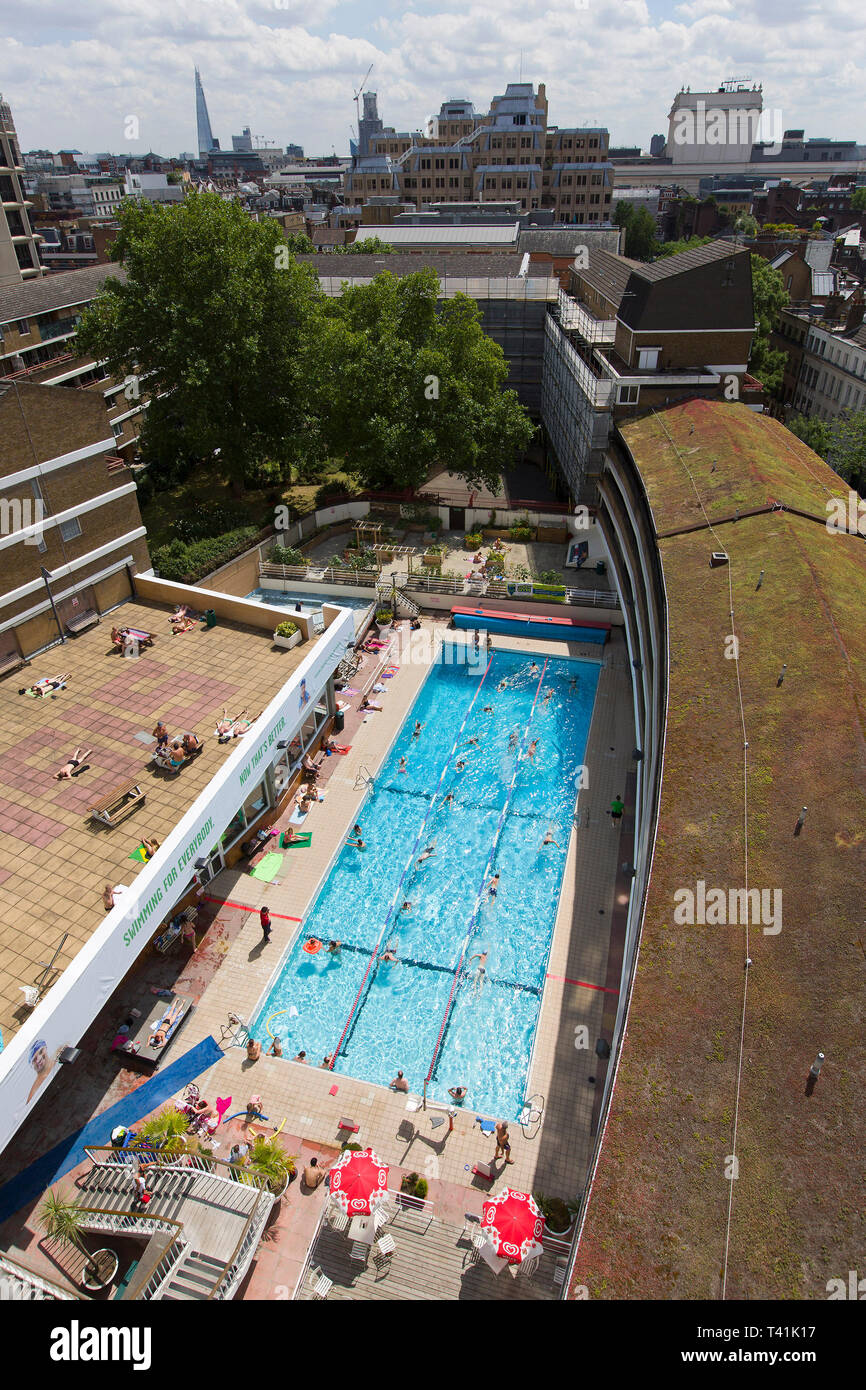 Swimmers enjoy the sunshine at an outdoor pool in central London on on ...