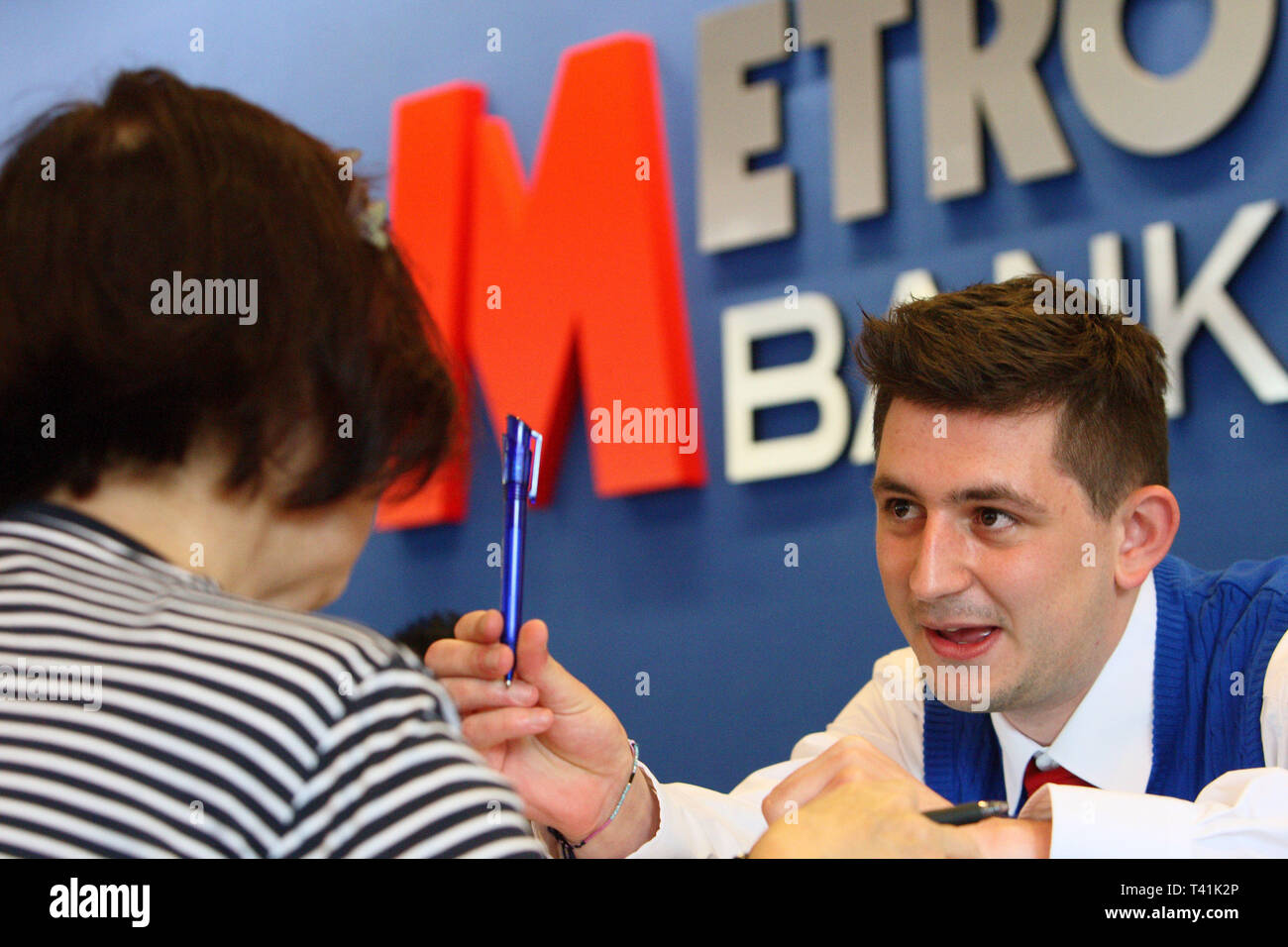 First branch of Metro Bank opens in Holborn. Customer opening an ...