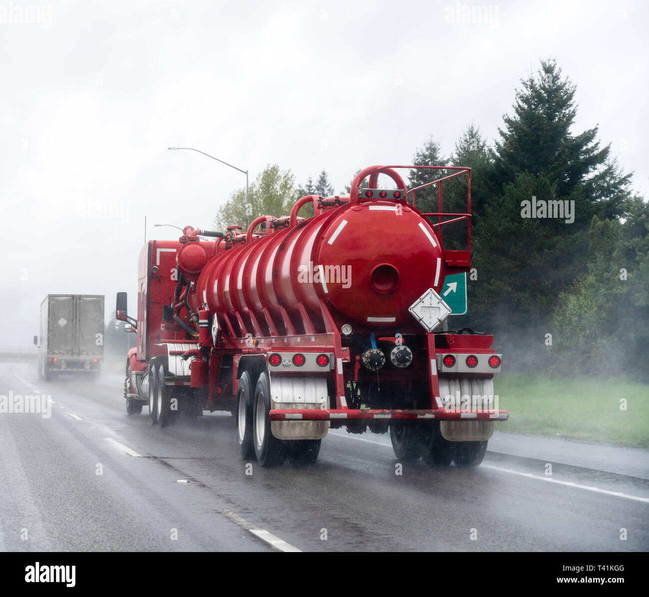 Red big rig industrial fright semi truck with tank semi trailer for ...