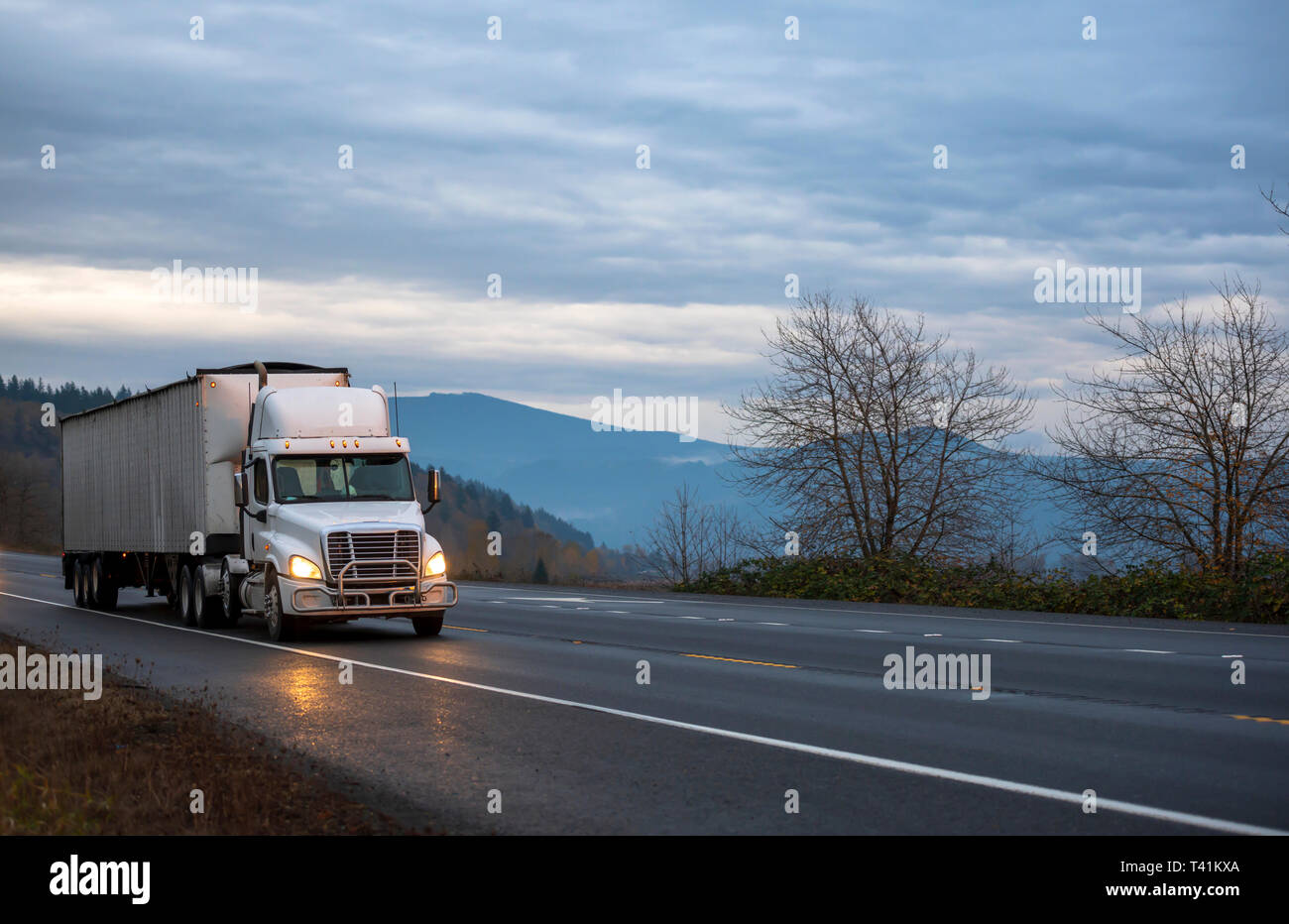 White day cab big rig semi truck with roof spoiler and turned on ...