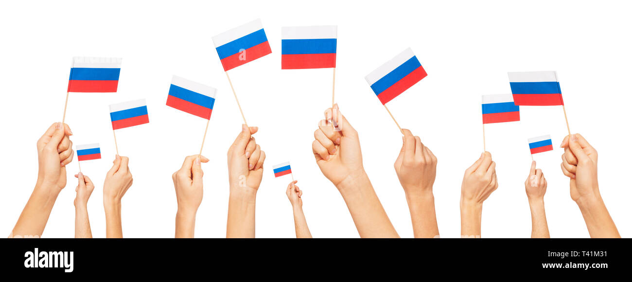 Hands holding and raising small flags of Russia Stock Photo - Alamy