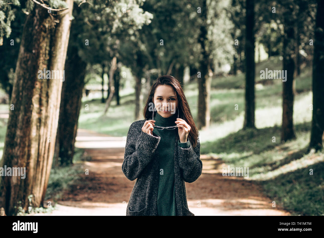 Portrait of a beautiful smiling girl in the forest Stock Photo - Alamy