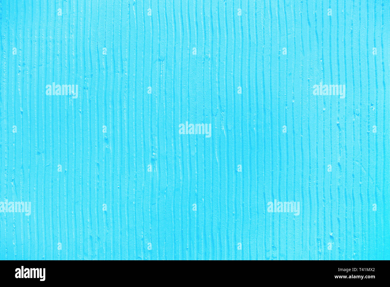 Closeup of the wall with a decorative blue colored plaster vertical ...