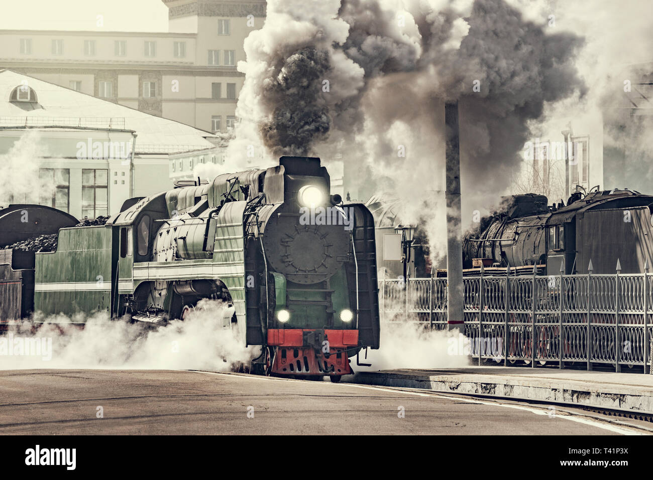 Steam train departs from the railway station Stock Photo - Alamy